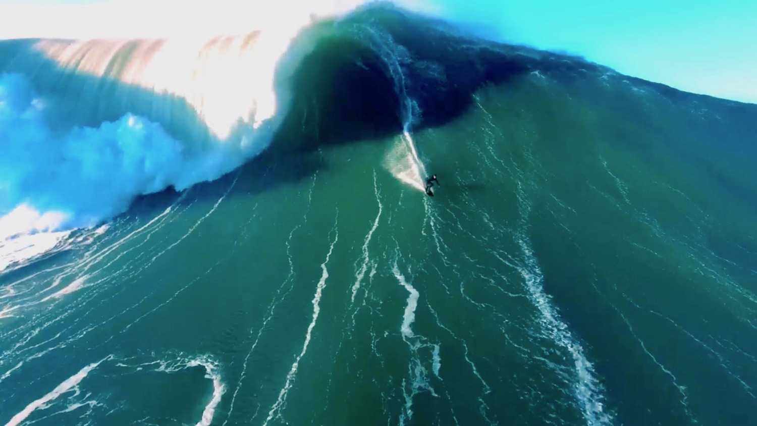 Drone video of surfer riding giant wave in Nazaré, Portugal