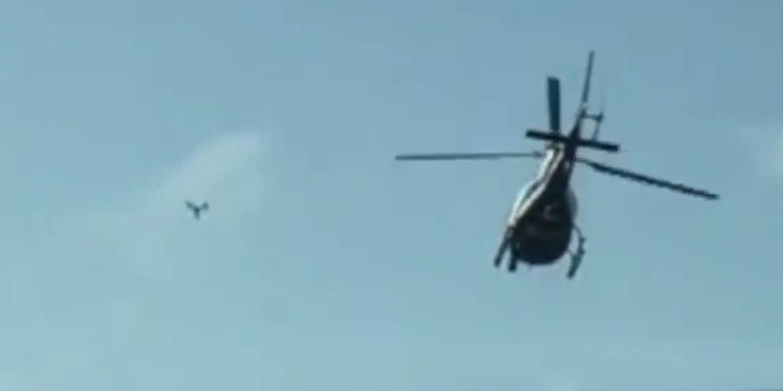 Drone has near miss with helicopter during police procession